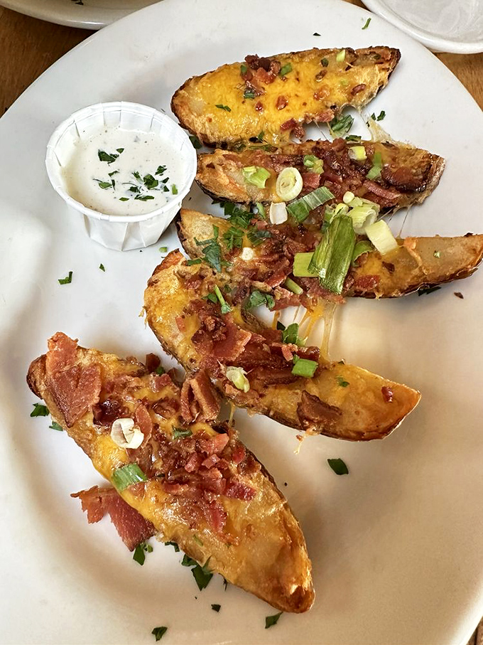 Potato skins that have achieved the golden trifecta: crispy exterior, fluffy interior, and toppings that don't hold back. 
