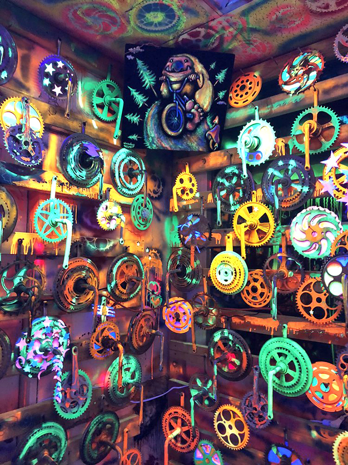 The black-light room turns ordinary bicycle parts into extraordinary art. Gears and sprockets become cosmic mandalas under ultraviolet glow.