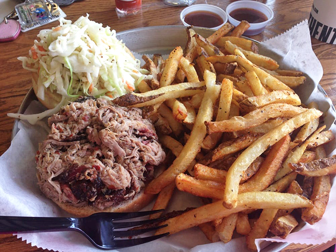 The pulled pork sandwich with fries&mdash;a masterclass in simplicity where smoke, tang, and potato perfection create the holy trinity of lunch satisfaction.