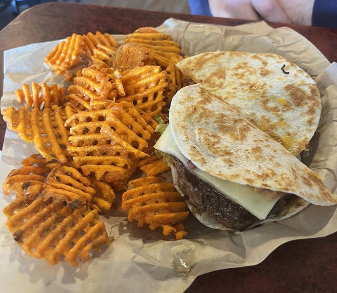 Waffle fries and a quesadilla burger &ndash; proof that culinary fusion isn't just for fancy restaurants. This is what happens when good ideas meet hungry people.