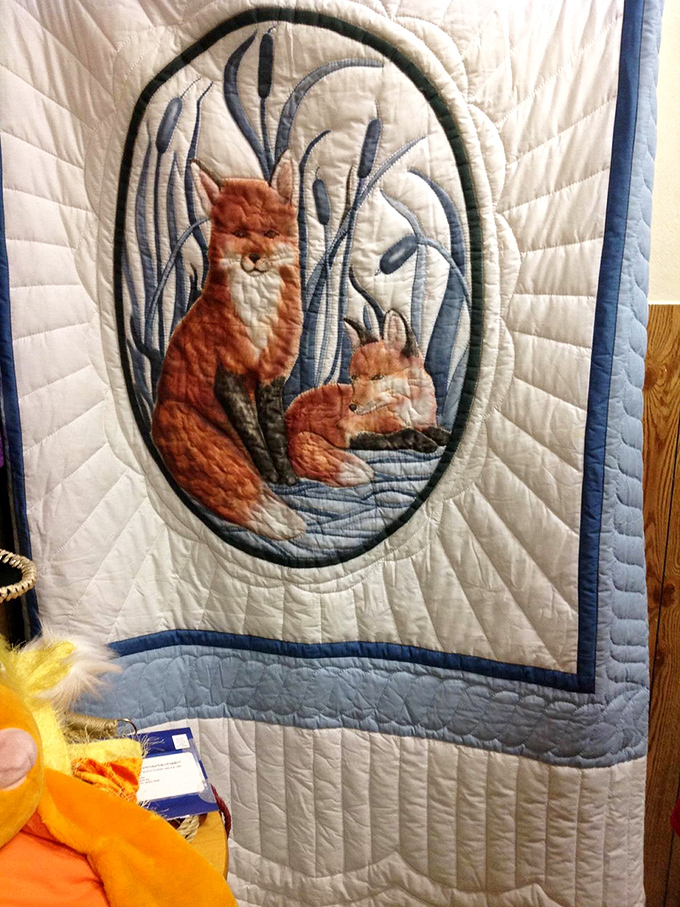 This handcrafted quilt featuring foxes among cattails isn't just bedding&mdash;it's functional folk art that kept someone warm through Ohio winters.