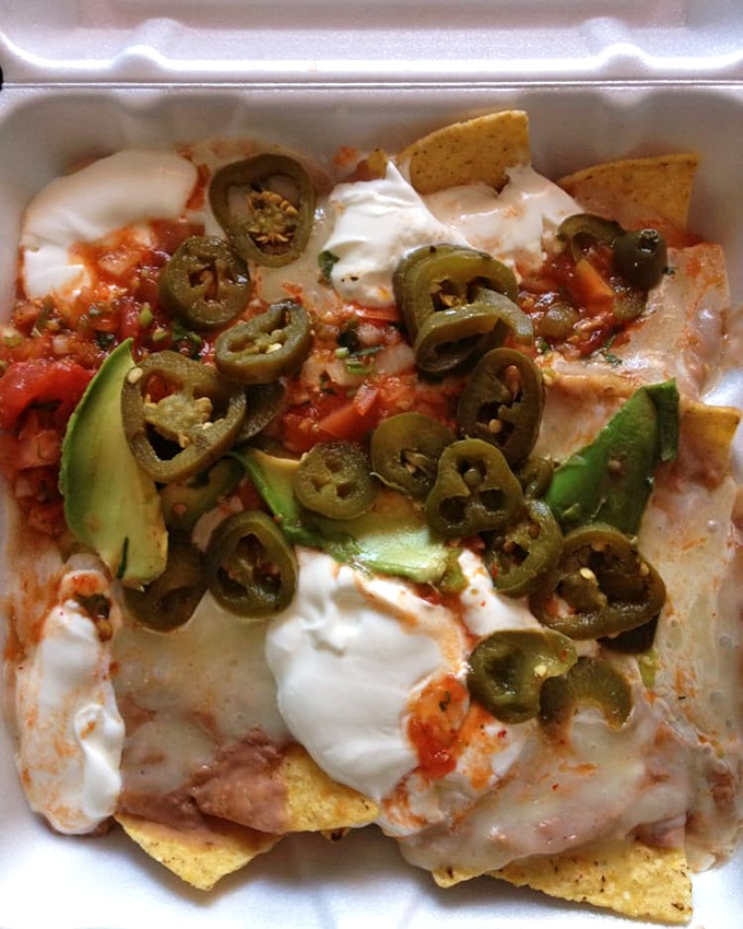 Nachos that understand the importance of proper topping distribution. Every chip deserves its moment of glory under those jalape&ntilde;os.