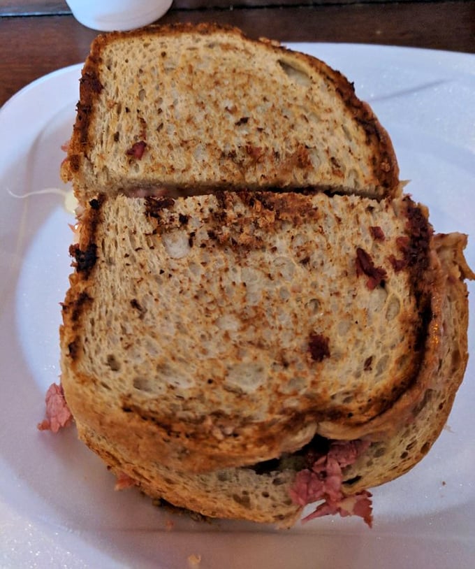 The Reuben sandwich &ndash; where toasty rye bread, tender corned beef, and tangy sauerkraut create a holy trinity of deli perfection. Worth every napkin you'll need.