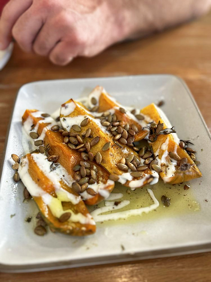 Roasted squash transformed into candy-like morsels, drizzled with creamy sauce and sprinkled with seeds. Vegetables having their glamour shot. 