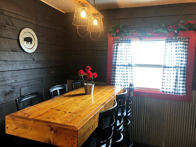 This farmhouse-style table could tell stories of countless barbecue pilgrimages. Red gerbera daisies add a pop of color against weathered wood walls.