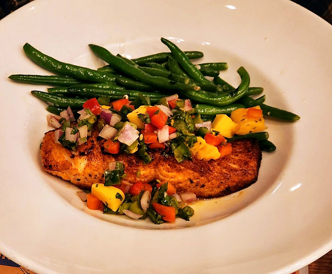 Perfectly seared salmon with vibrant vegetables that eat like a color therapy session. The green beans stand at attention, ready for their supporting role.