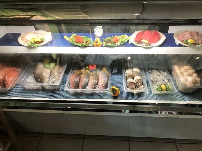 The seafood display case showcases tomorrow's dinner like precious jewels, each selection promising its own culinary adventure.