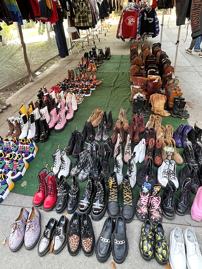 A boot lover's paradise spread across green canvas &ndash; where Doc Martens, cowboy boots, and platform shoes create a footwear United Nations.