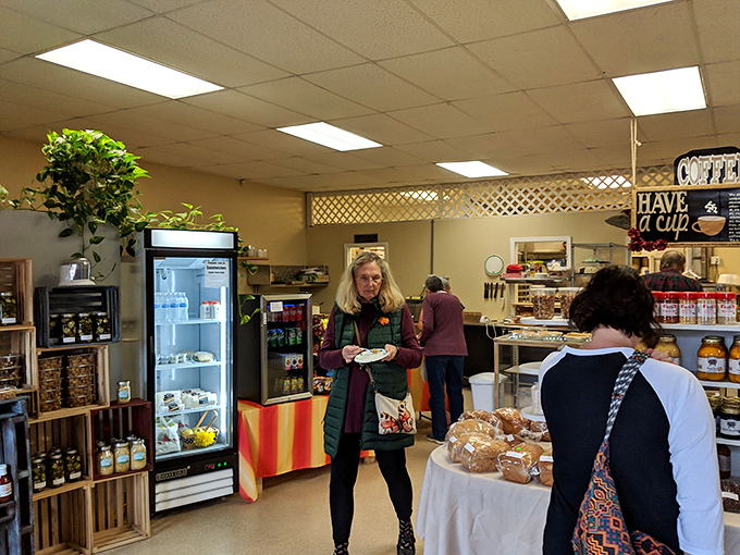 Customers navigating the bakery like treasure hunters on a delicious expedition. The focused expressions say it all: serious food decisions are being made.