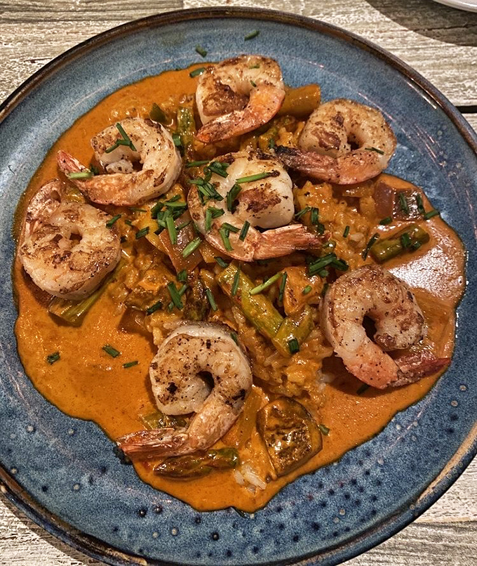 Shrimp arranged like synchronized swimmers in a curry pool so luscious you'll want to request a spoon for the sauce alone. This dish doesn't just satisfy&mdash;it transports.