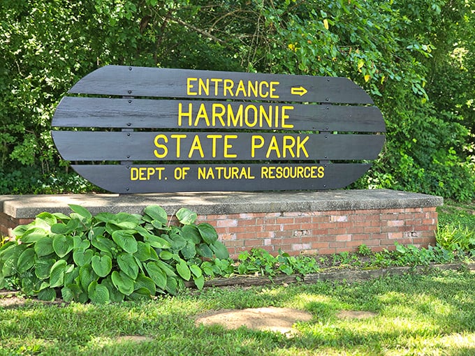 Summer at the park entrance: where lush hostas frame the welcome sign like nature's own green carpet.