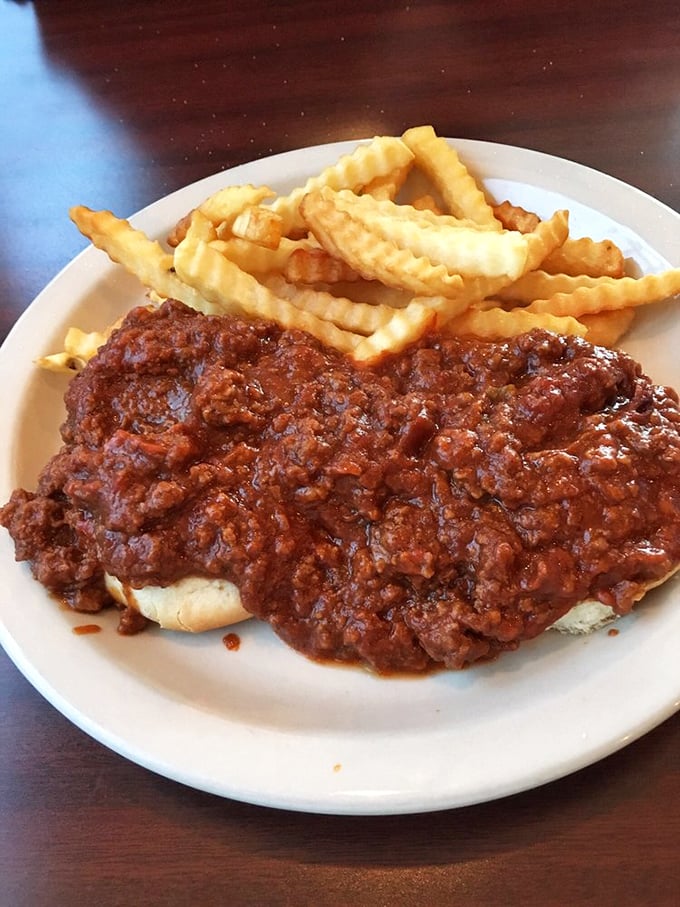 A masterclass in comfort food physics: the perfect meat-to-bun ratio topped with that rich, savory sauce that demands french fries for dipping.