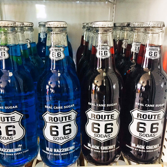 Route 66 sodas lined up like liquid postcards, offering a sweet, fizzy taste of nostalgia with every sip.