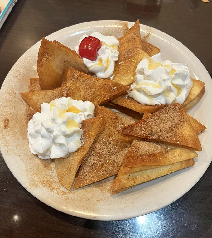 Sopapillas dusted with cinnamon sugar and topped with whipped cream&mdash;dessert that makes you wonder why you saved room.