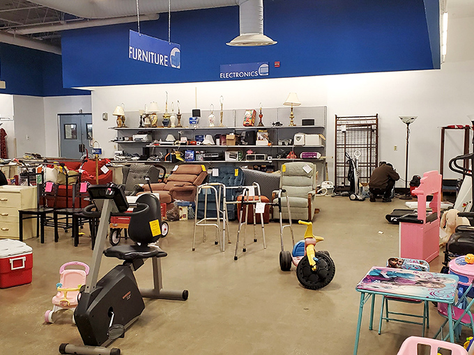 The furniture section expands like a showroom designed by chance. Exercise equipment mingles with end tables in this democratic display of household possibilities.