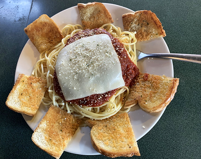Spaghetti surrounded by a golden garlic toast fortress&mdash;carb heaven that would make your Italian grandmother nod in approval.