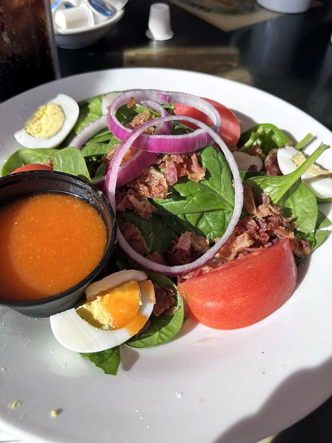 This spinach salad with its vibrant rings of red onion proves that Trip's can do healthy too &ndash; though we won't tell if you follow it with pancakes.