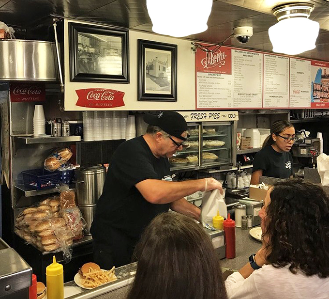 Behind the counter, the staff orchestrates the breakfast ballet with practiced precision, turning orders into edible art.