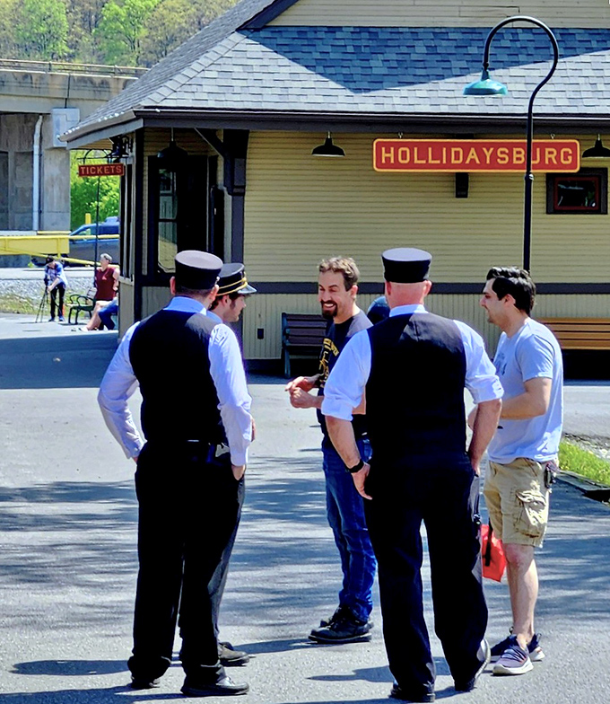 The conductors share tales of the rails with visitors, their traditional uniforms completing this immersive journey into railroad history.