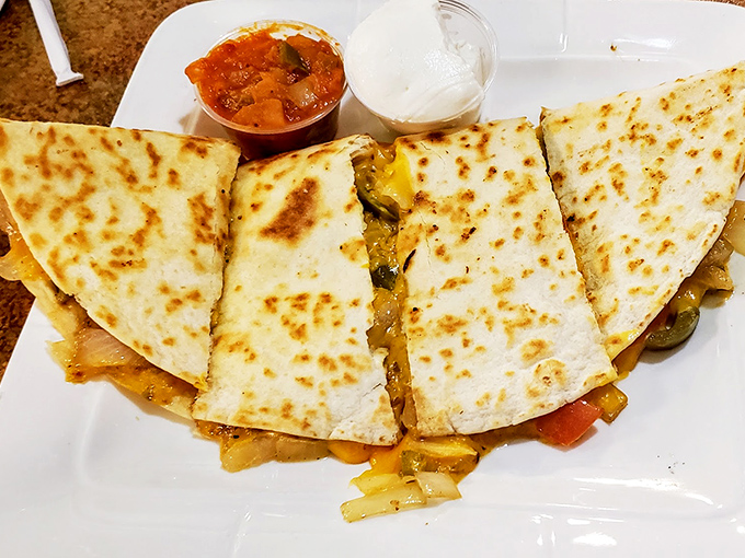 Quesadillas that make you question why you ever bothered with tacos. Cheese pulling double duty as both ingredient and entertainment.