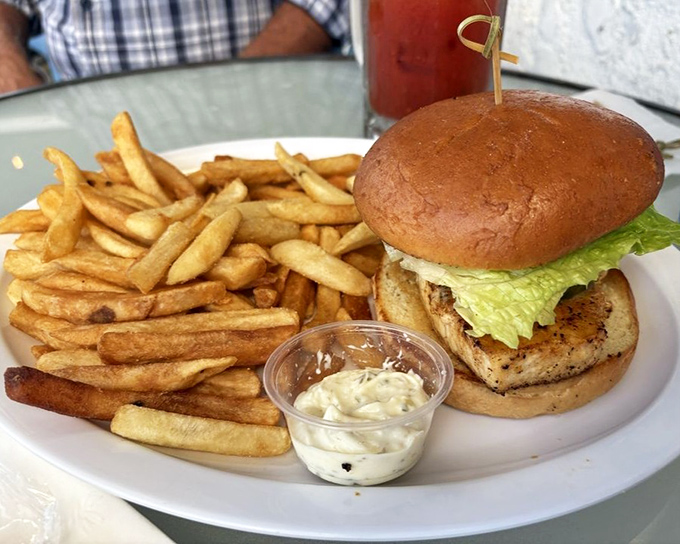 A sandwich that requires both hands and your full attention. Those fries aren't a side dish&mdash;they're co-stars in this plate's delicious drama.