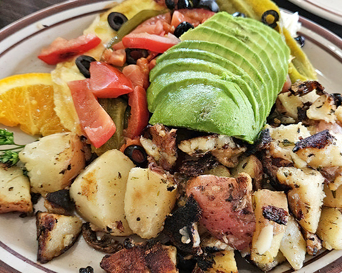 An omelet that's practically wearing a sombrero. Fresh avocado, vibrant veggies, and home fries that deserve their own fan club.