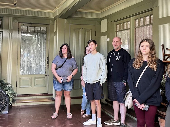 Tour groups gather in the soft green parlor, where guides share tales of spiritualism, superstition, and Sarah Winchester's endless construction.