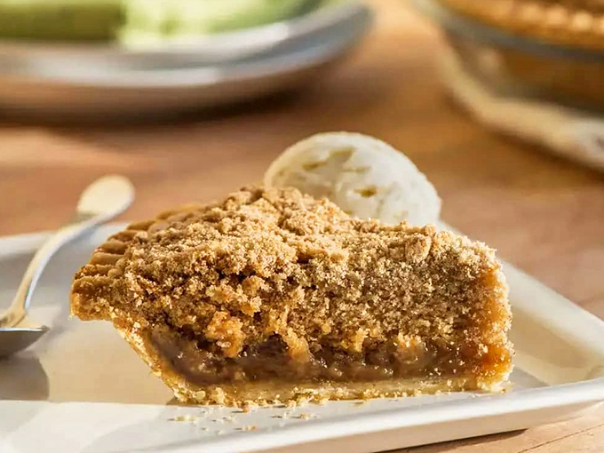 A slice of pie that whispers sweet nothings to your taste buds, with a golden crumb topping that crackles with each forkful.