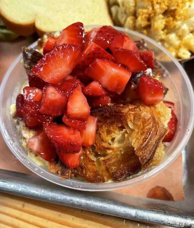 Tres leches bread pudding topped with fresh strawberries. Proof that dessert stomachs exist, even after consuming your weight in brisket.