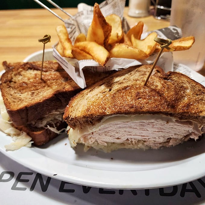 A sandwich architecture masterpiece that makes you wonder why anyone would eat lunch standing up. Those potato wedges are no afterthought either.