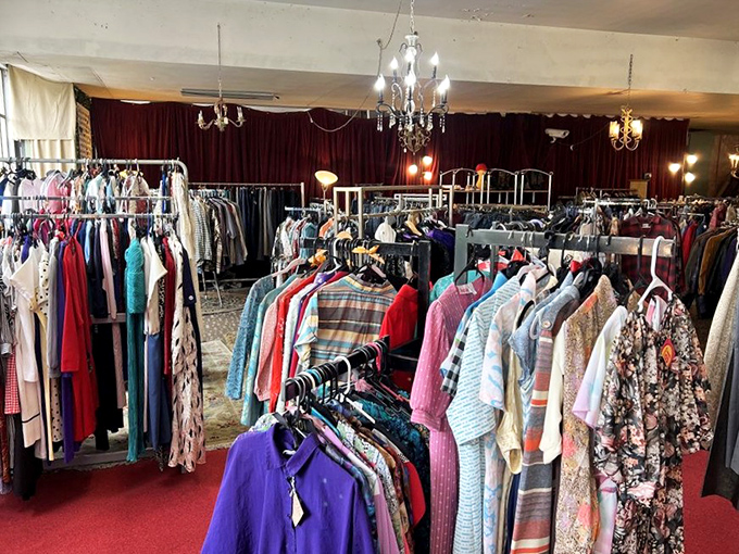 A kaleidoscope of vintage fashion where every hanger holds a different decade. That purple shirt? Pure 1970s confidence in fabric form.