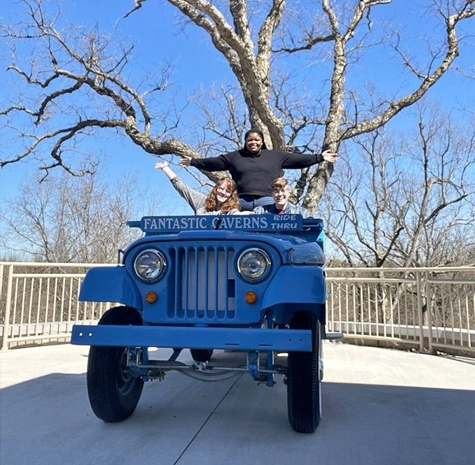 "I'm king of the underground world!" Visitors enjoy a photo opportunity with one of the distinctive blue Jeep-drawn trams.