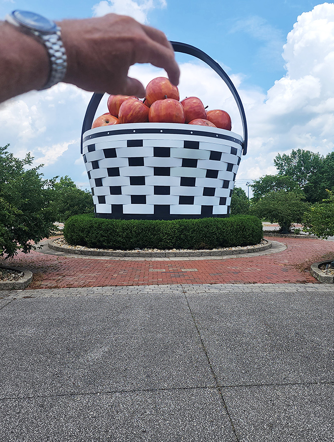 The classic "holding up the basket" shot! Every visitor inevitably attempts this optical illusion, creating the perfect souvenir of their brush with oversized Americana.