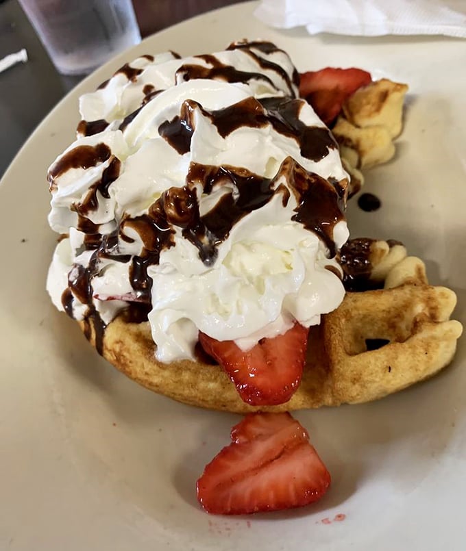 A waffle that's clearly showing off for the camera. With whipped cream, strawberries, and chocolate, it's basically breakfast dessert&mdash;and that's perfectly okay.