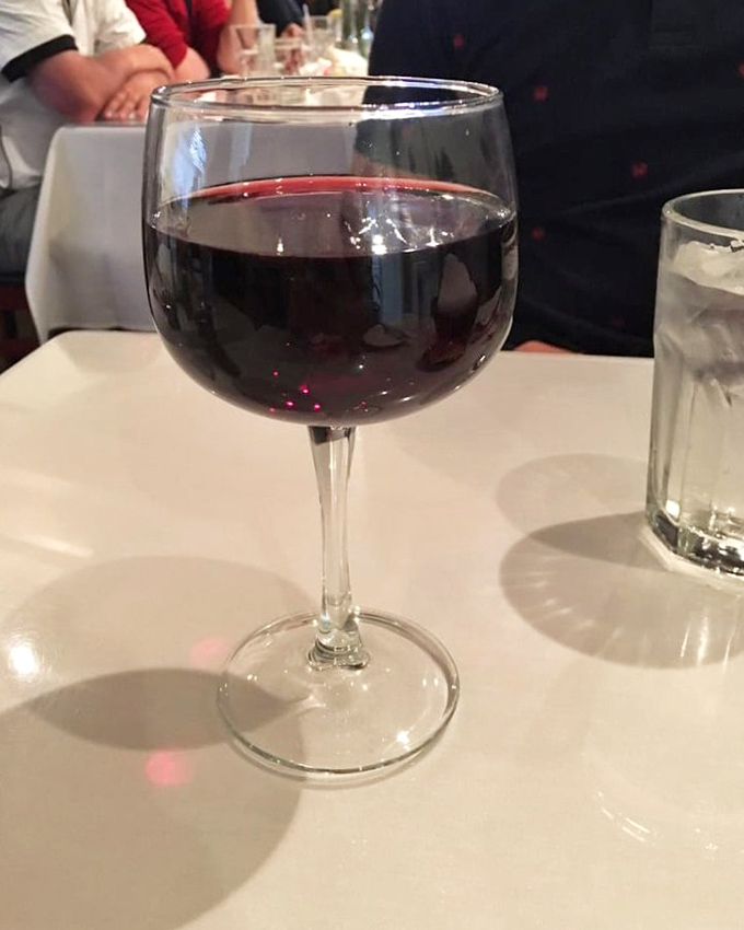 A glass of ruby-red wine&mdash;the perfect companion for seafood adventures. Simple pleasures are often the most profound. 
