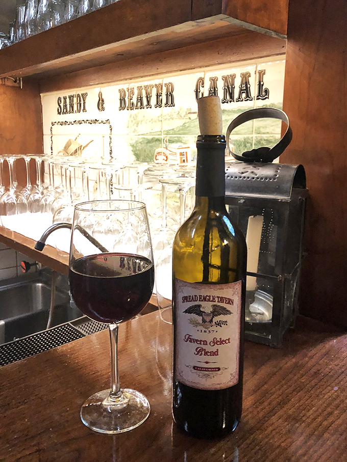 The tavern's own wine sits proudly against a backdrop celebrating local history&mdash;proof that good taste and good stories often come from the same place.