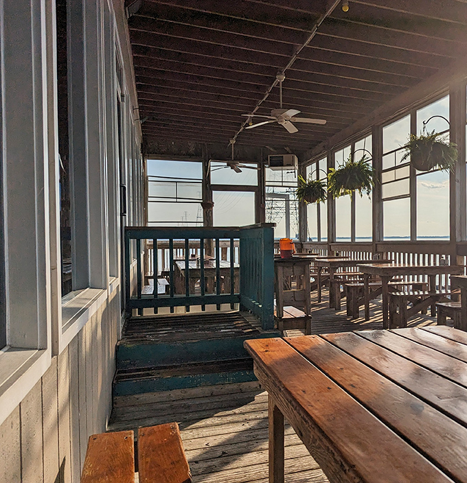 The screened porch dining area&mdash;where the James River breeze carries away your worries and occasionally tries to steal your napkin.