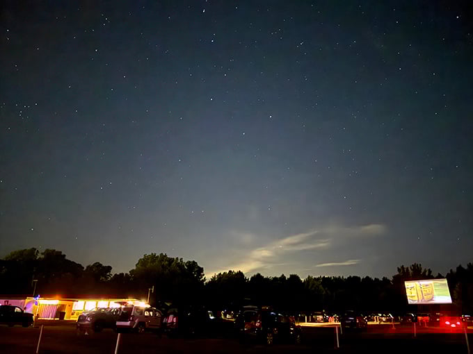 When night fully descends, the drive-in transforms into a magical landscape of starlight above and screen glow below.
