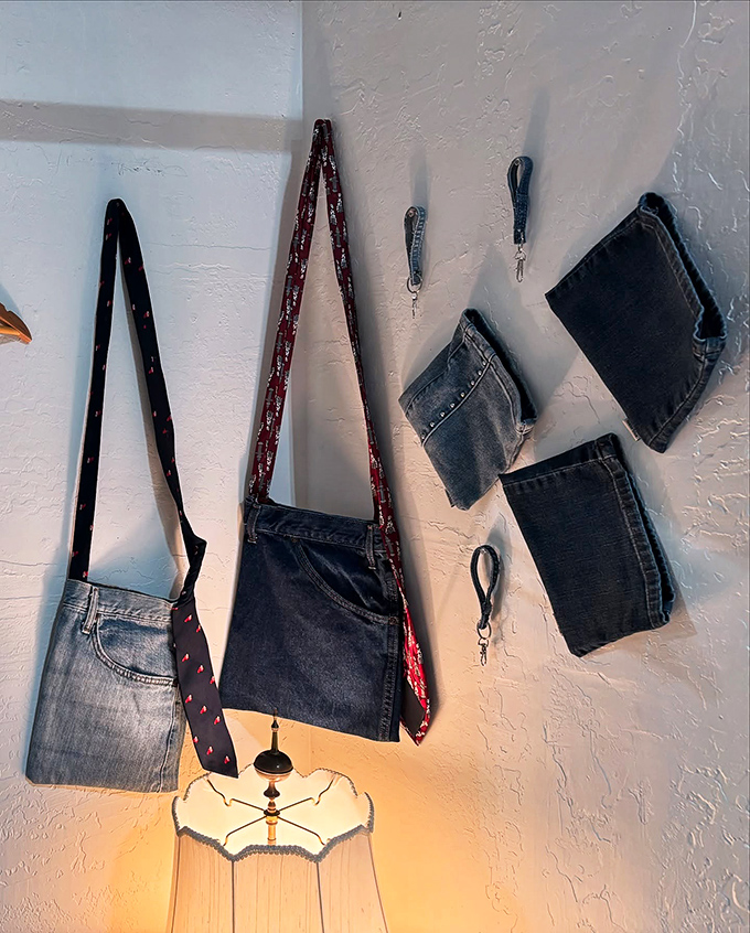 Upcycled denim bags hang alongside wallets, proving that yesterday's jeans can become today's most conversation-worthy accessories.