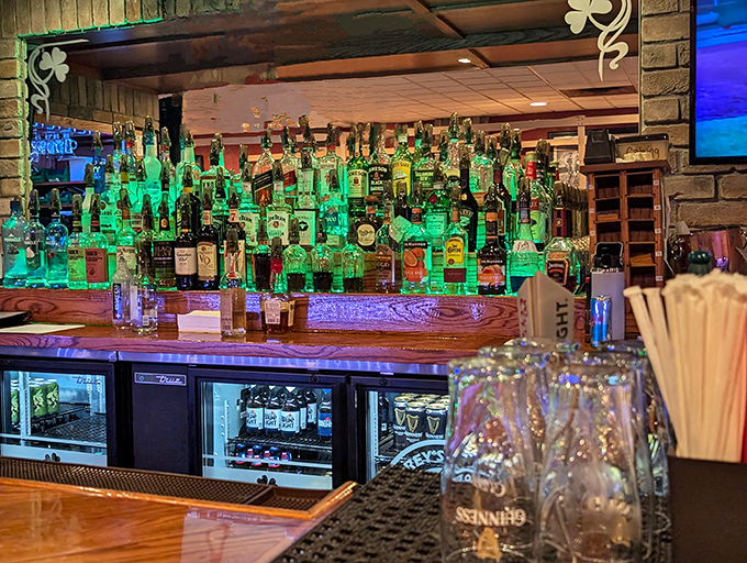 The bar's emerald glow illuminates an impressive spirits collection. This isn't just a sandwich spot—it's where Erie comes to celebrate.