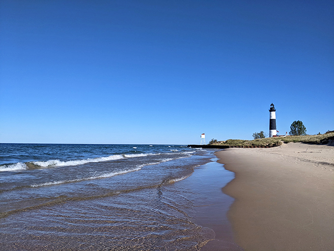Not just any beach&mdash;this is where Lake Michigan's waves meet pristine sand, with another lighthouse standing guard in the distance.