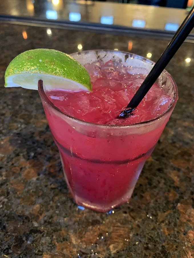 This isn't just a cocktail; it's summer in a glass. That vibrant color promises refreshment with a kick that'll make your taste buds dance.