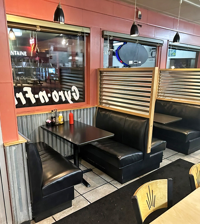 These booths have witnessed countless first dates, family celebrations, and regular Tuesday lunches. The corrugated metal and red walls create that perfect diner atmosphere.