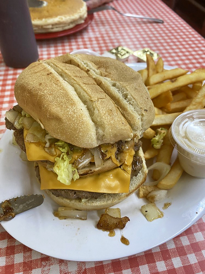 This isn't just a cheeseburger; it's architectural perfection with melty cheese cascading down like a yellow waterfall of joy.