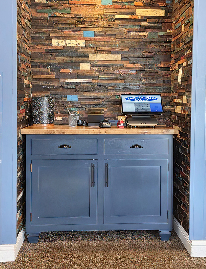 The host station's reclaimed wood wall adds warmth without trying too hard. Michigan rustic meets breakfast chic.
