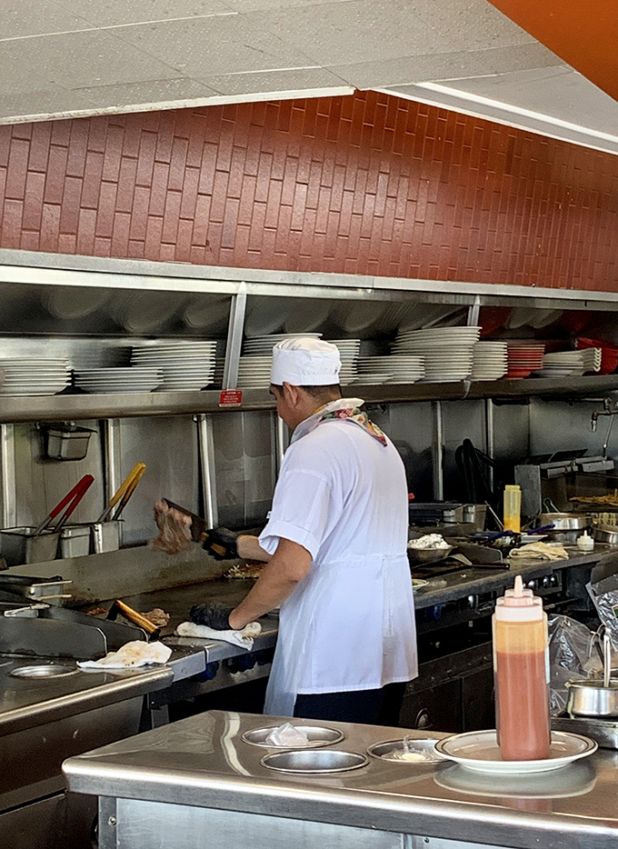 Behind the scenes magic. The kitchen staff moves with the efficiency of a well-oiled machine, turning out comfort food classics at impressive speed.