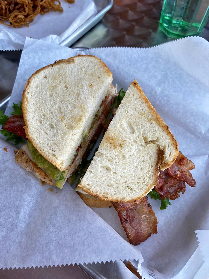 The humble sandwich, elevated to art form. Perfectly toasted bread embracing its fillings like old friends reuniting after too much time apart.