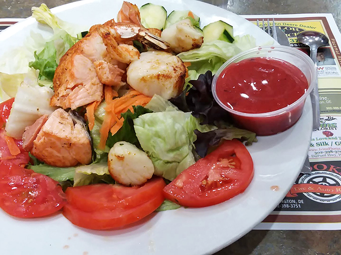 A salad that refuses to apologize for its generous portions, where shrimp and scallops turn lettuce into a celebration.