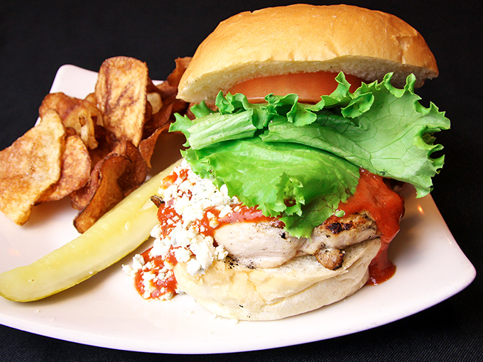A chicken sandwich that doesn't know it's not the star of the menu&mdash;crisp lettuce, juicy tomato, and house-made chips create a lunchtime symphony.