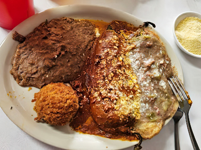 A plate that doesn't know the meaning of empty space &ndash; chili relleno, refried beans, and Spanish rice creating a holy trinity of satisfaction.
